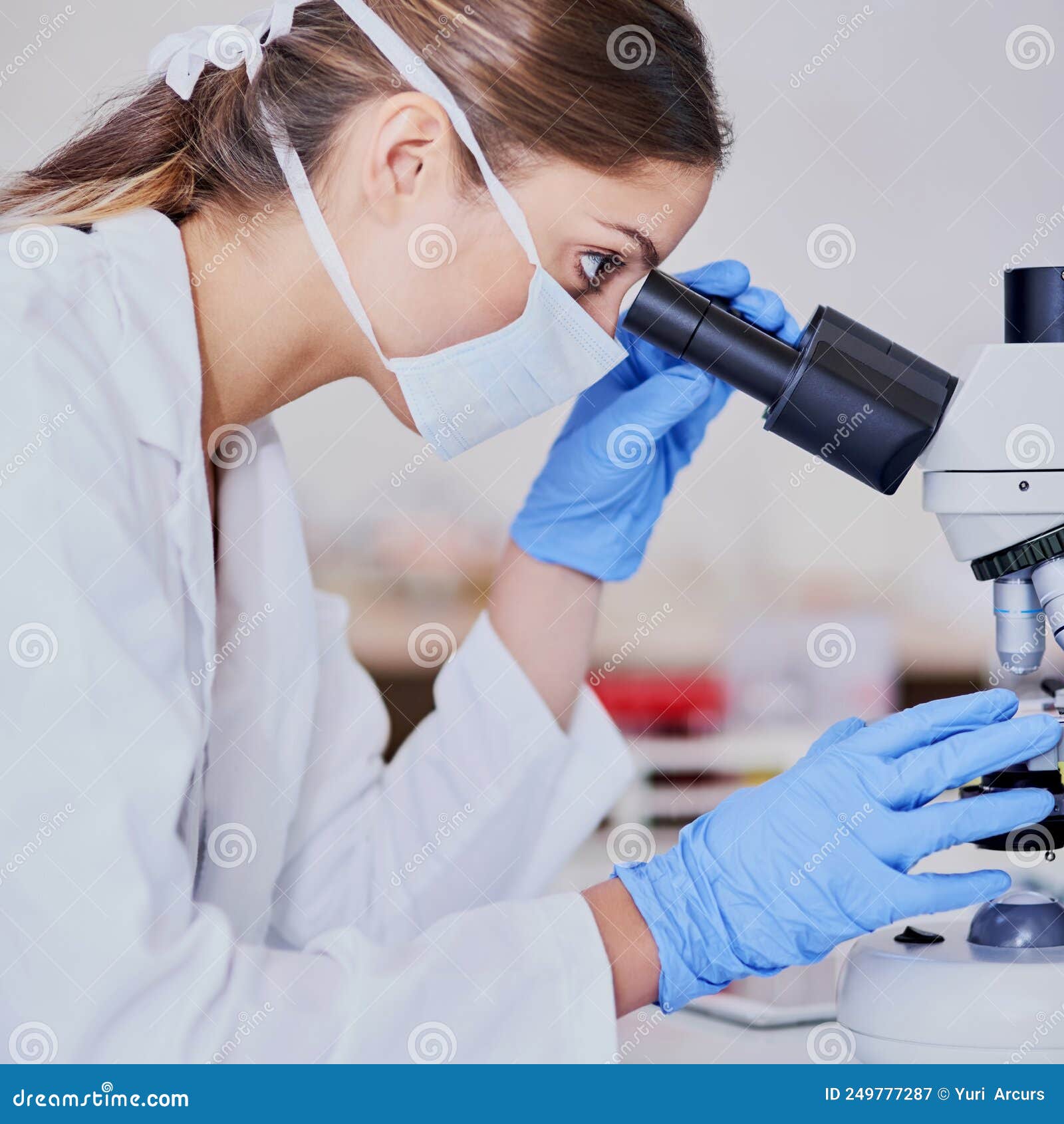 Searching for Microscopic Clues. Shot of a Scientist Using a Microscope ...