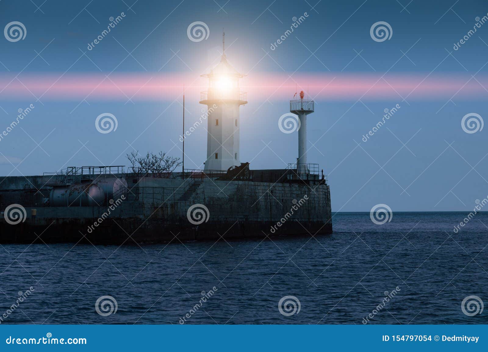 Searchlight Rays from Lighthouse Lamp on Concrete Pier in Twilight ...