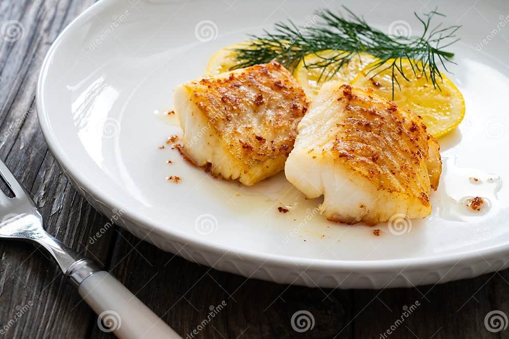 Seared Cod Loin and Sliced Lemon on Wooden Table Stock Photo - Image of ...