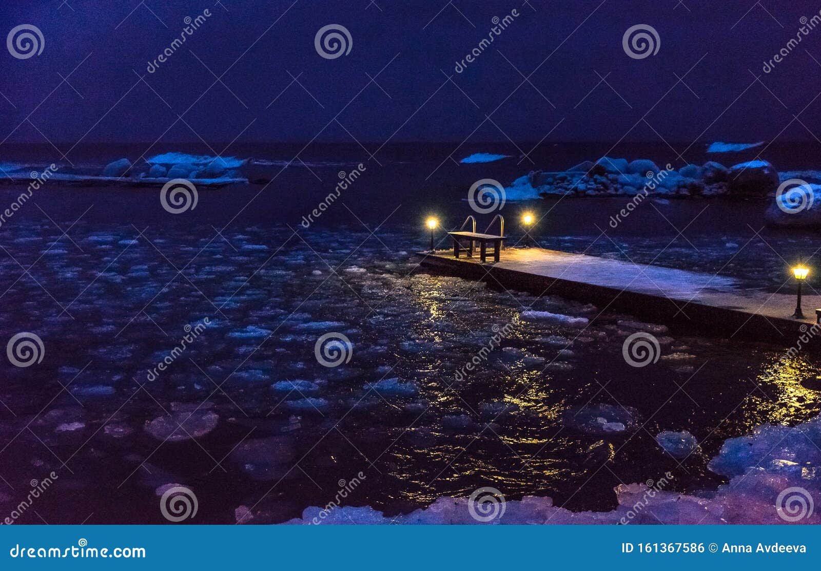 Seascape with Night Lake with Lights on a Pier and Floating Ice Stock ...