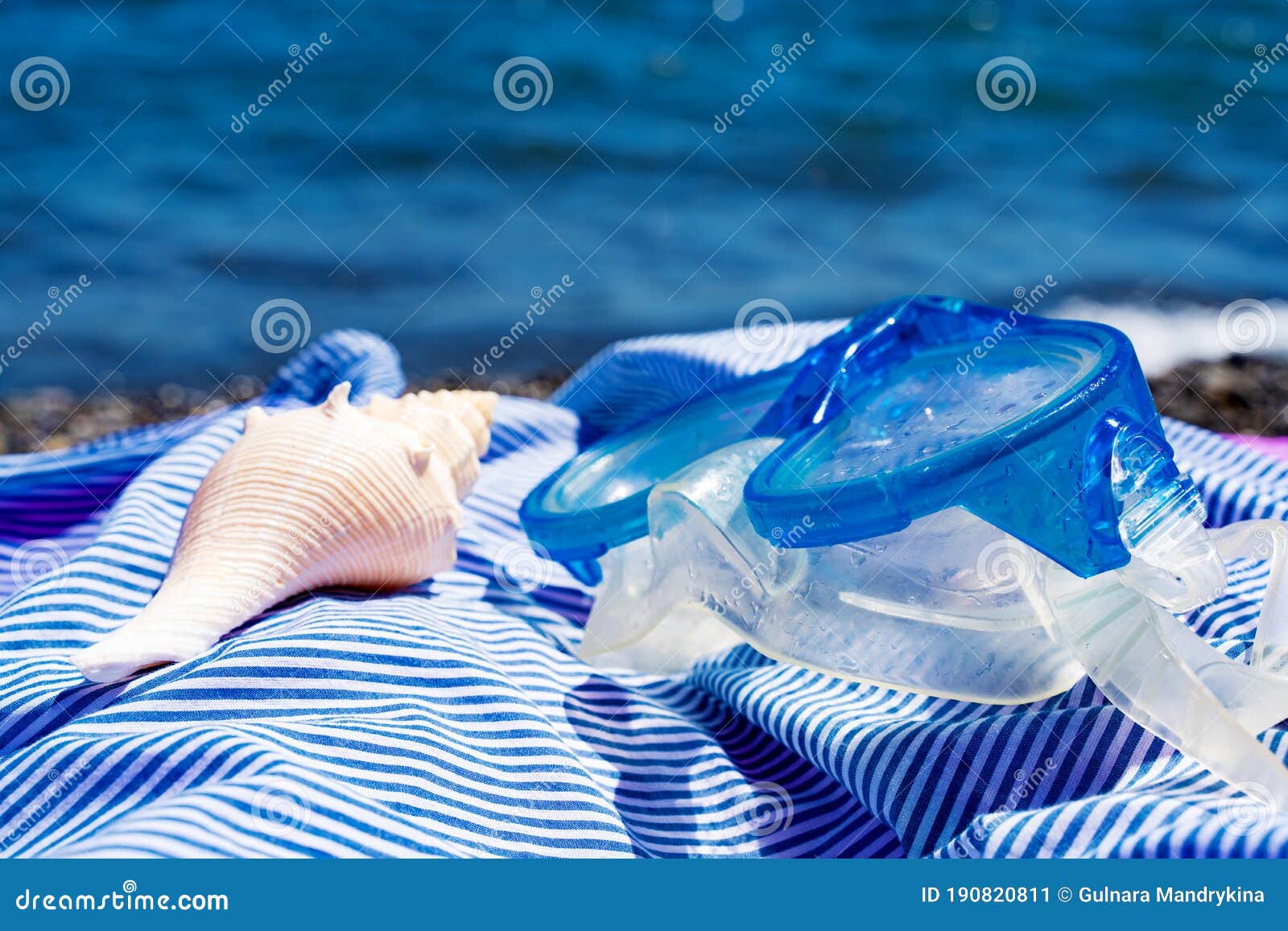 Seashell and Diving Glasses on the Background of the Blue Sea Stock ...