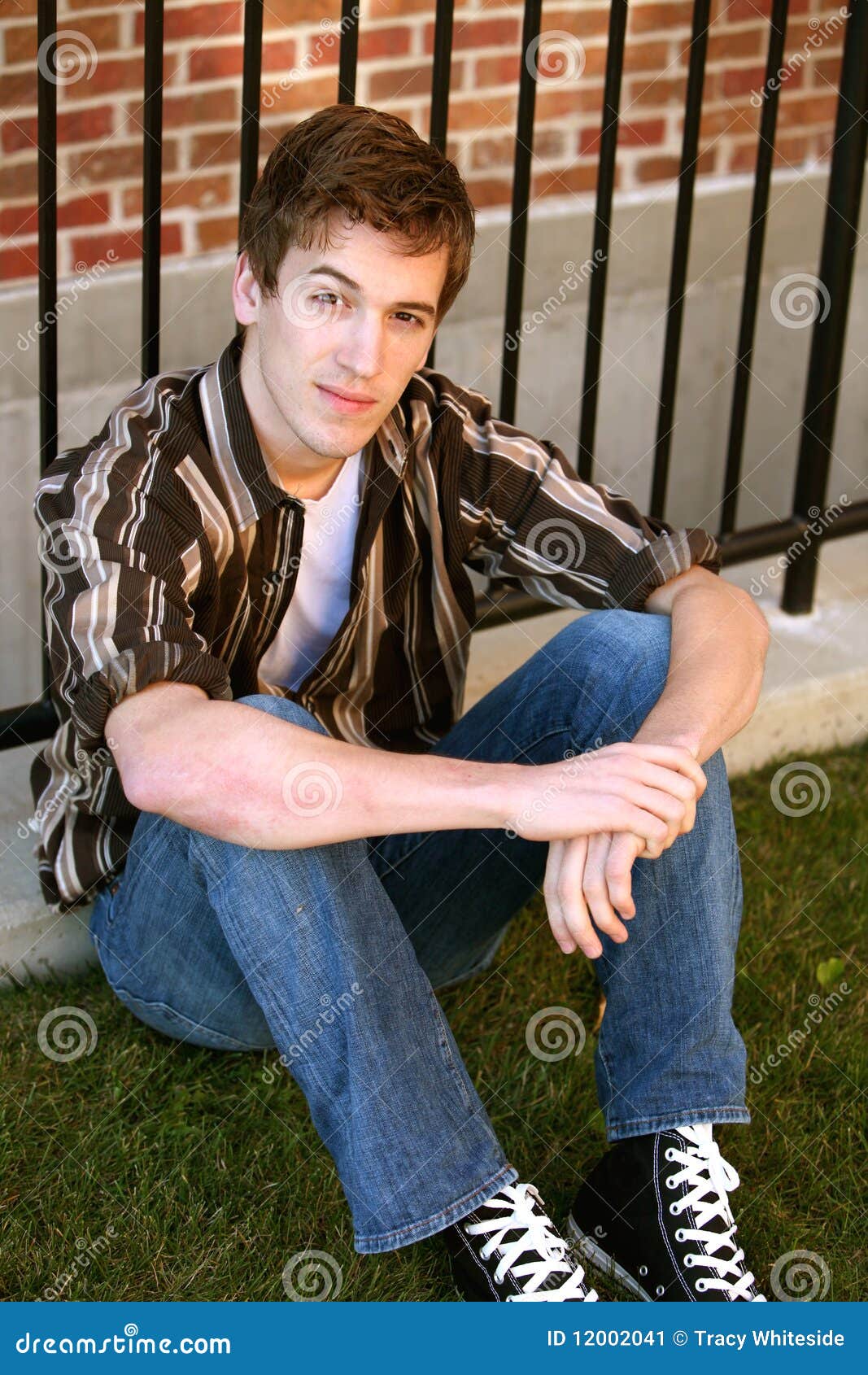 Seated guy against railing stock image. Image of real - 12002041