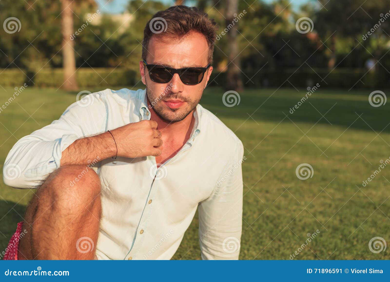 Seated Man in the Outdoors Holding His Collar Stock Image - Image of ...