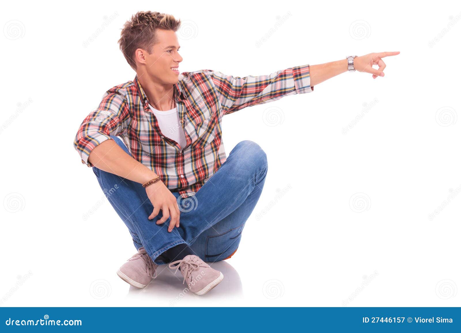 Seated Young Man Pointing To Side Stock Image - Image of happy, latin ...