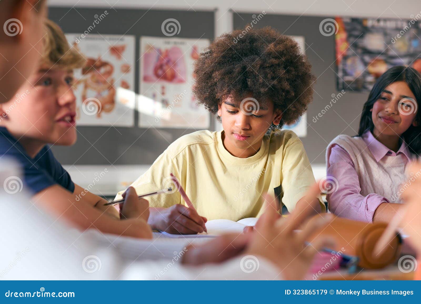 Secondary or High School Students Sitting Around Table in Science Class ...