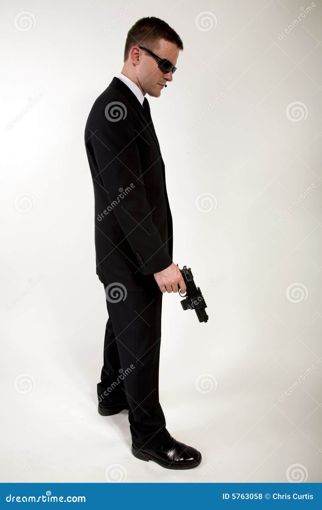 Secret Agent holding Gun stock photo. Image of formal - 5763058