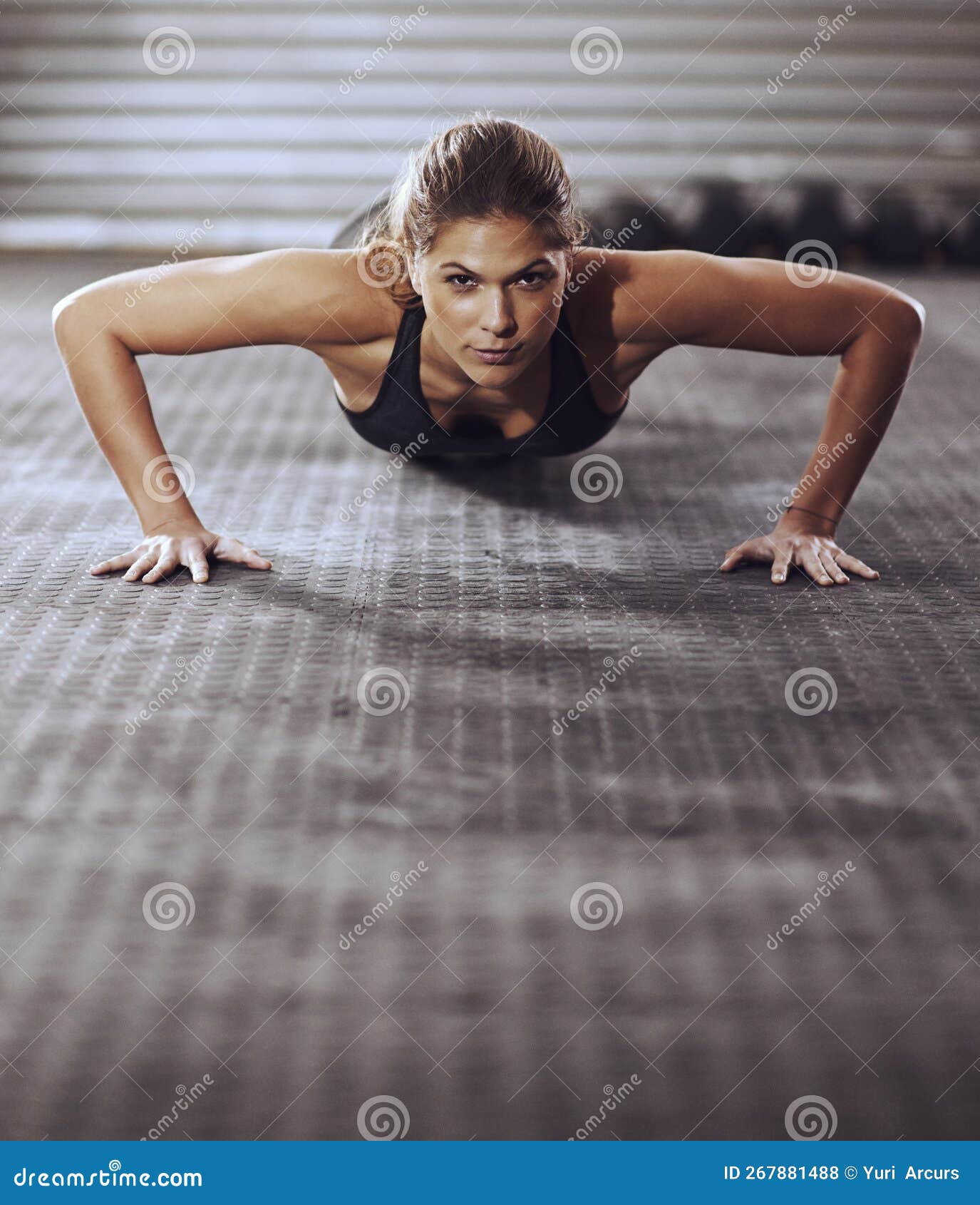 The Secret is Dedication. a Young Woman Doing Push-ups at the Gym ...