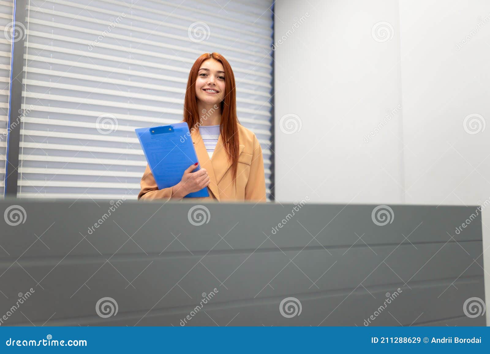 Secretary with Clipboard in Hands Stands at the Office Reception Stock ...