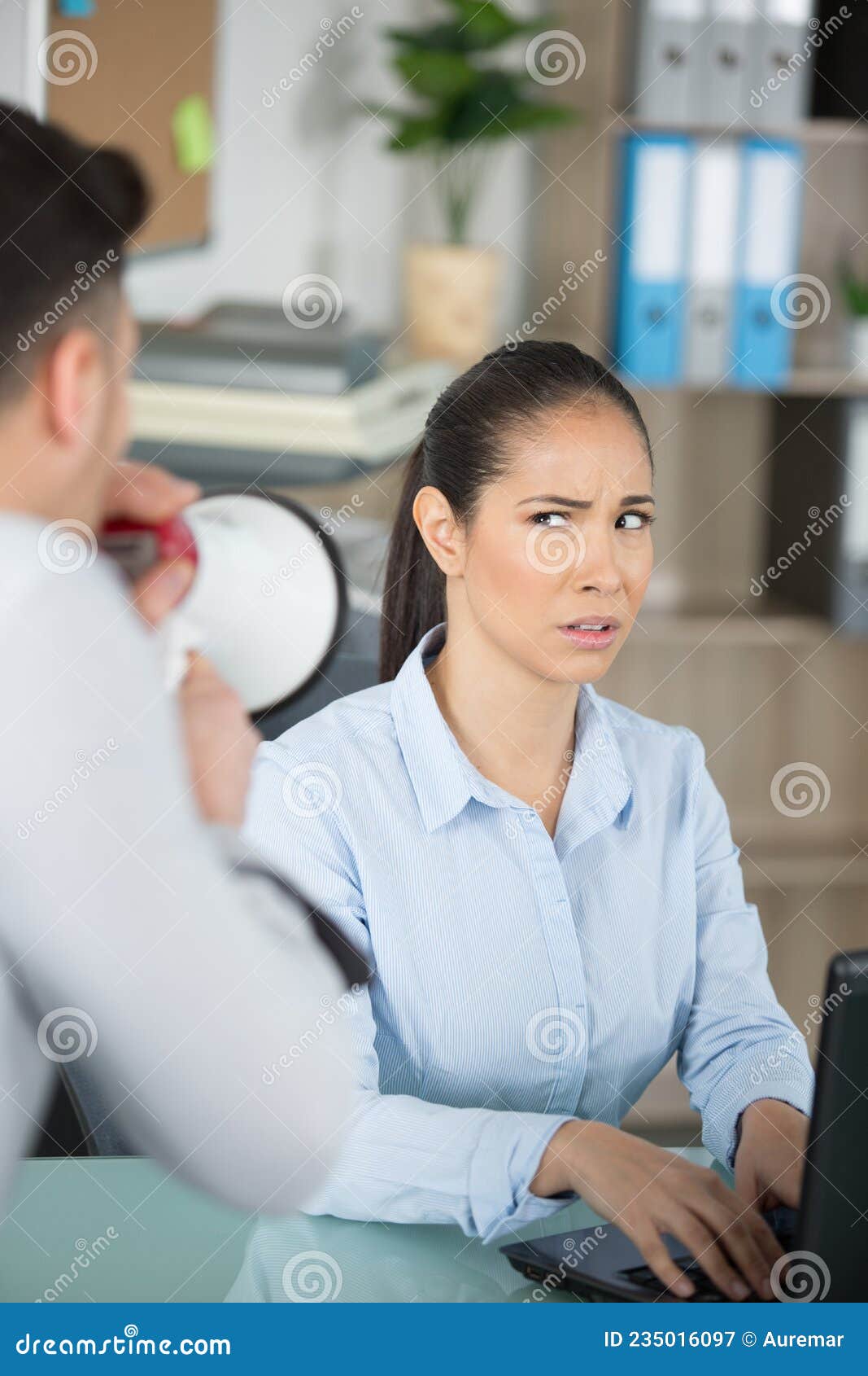 Secretary Looking Disdainfully at Colleague Talking through Megaphone ...