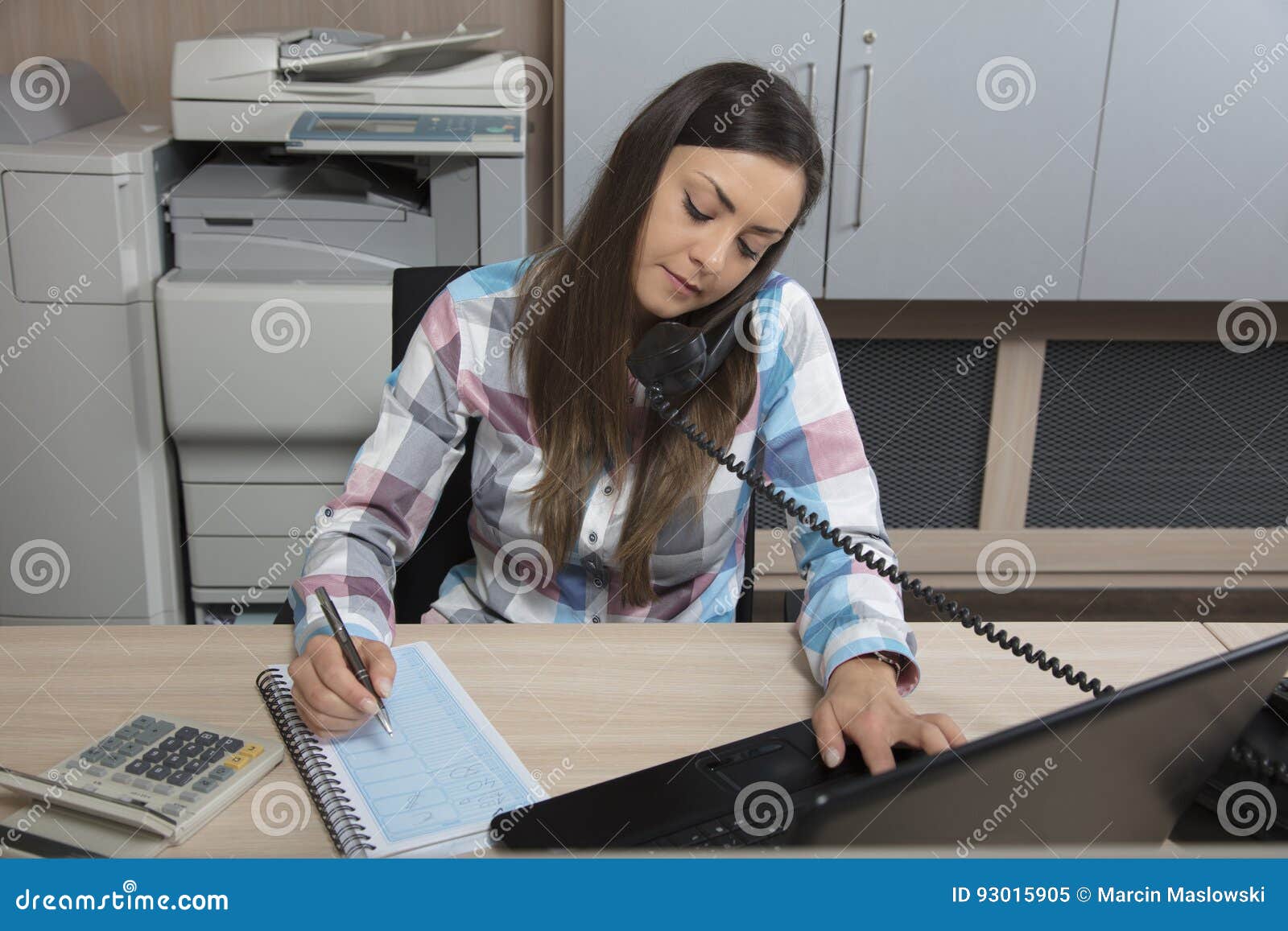 The Secretary is Making Notes and Talking on the Phone at the Sa Stock ...