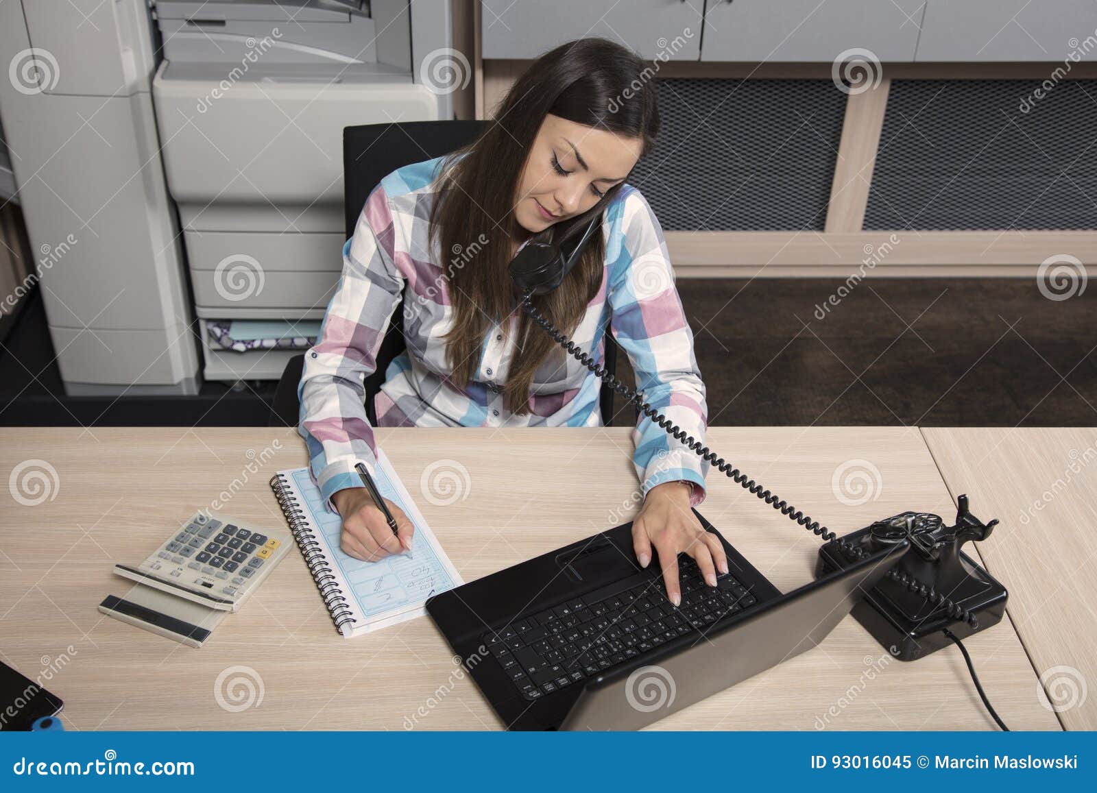 The Secretary is Making Notes and Talking on the Phone at the Sa Stock ...