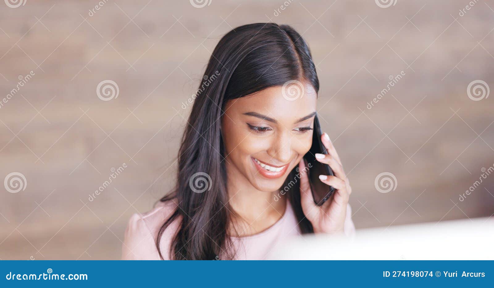 Secretary Talking on a Phone while Working on a Computer at a Front ...