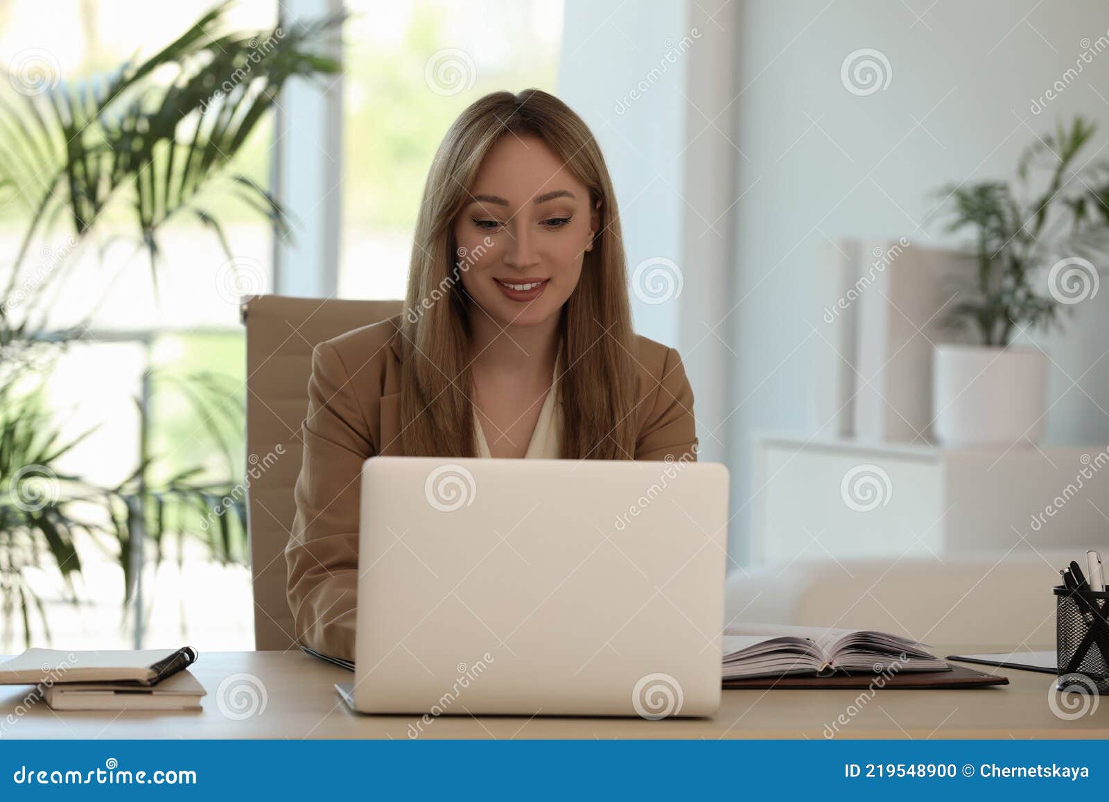 Secretary Working with Laptop at Wooden Table in Office Stock Photo ...