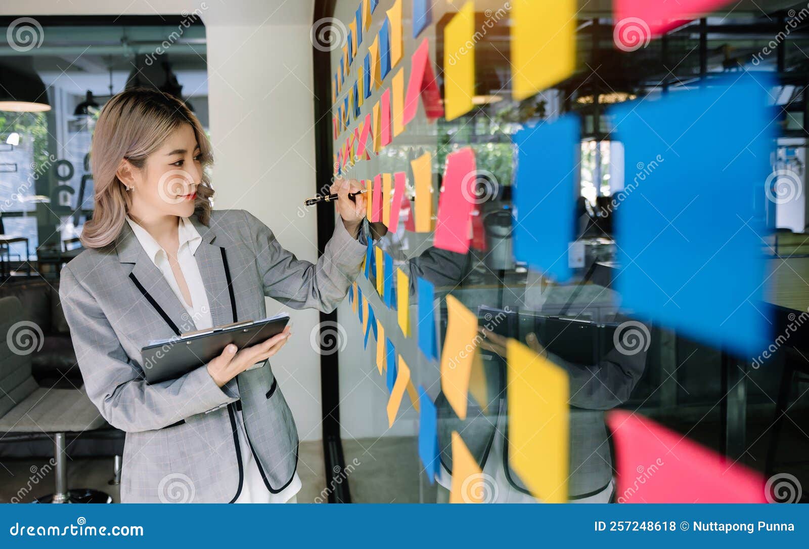Secretary Working in Modern Office in Skyscraper, Writing and Sticking ...
