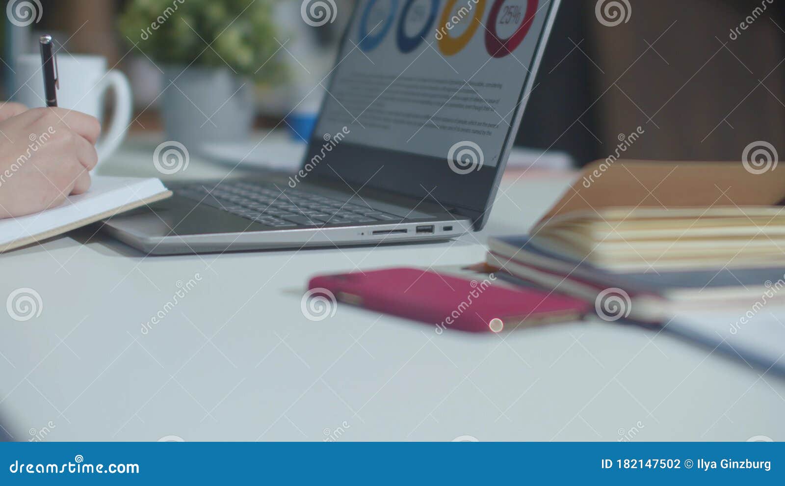 The Secretary Writes a Note and Works with the Laptop Stock Photo ...