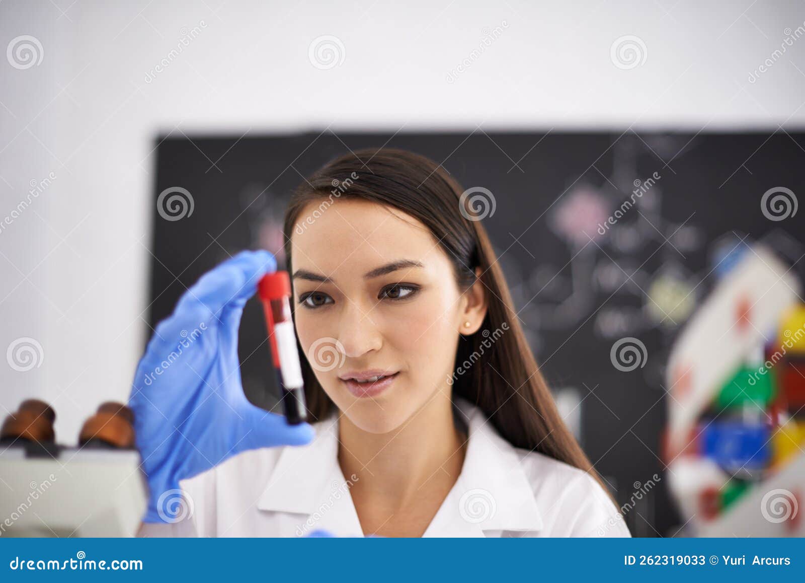 The Secrets of Genetics in Blood. a Female Scientist Holding a Blood ...