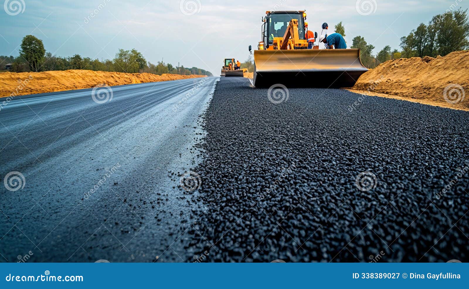 A Section of an Asphalt Road Under Construction with Visible Machinery ...