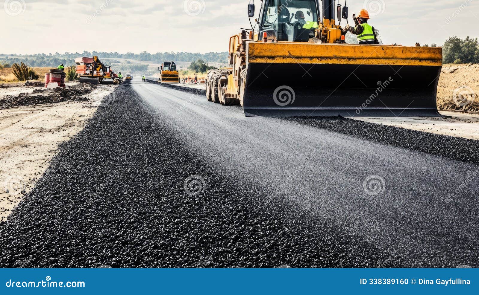 A Section of an Asphalt Road Under Construction with Visible Machinery ...