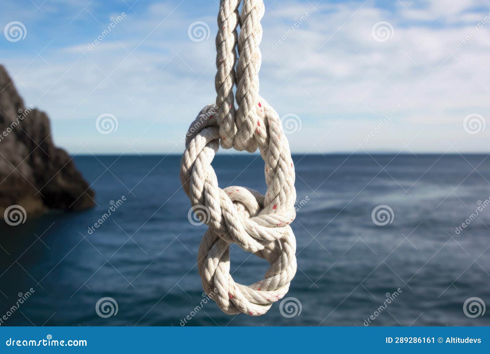 Secure Bowline Knot on a White Rope with Ocean Backdrop Stock ...