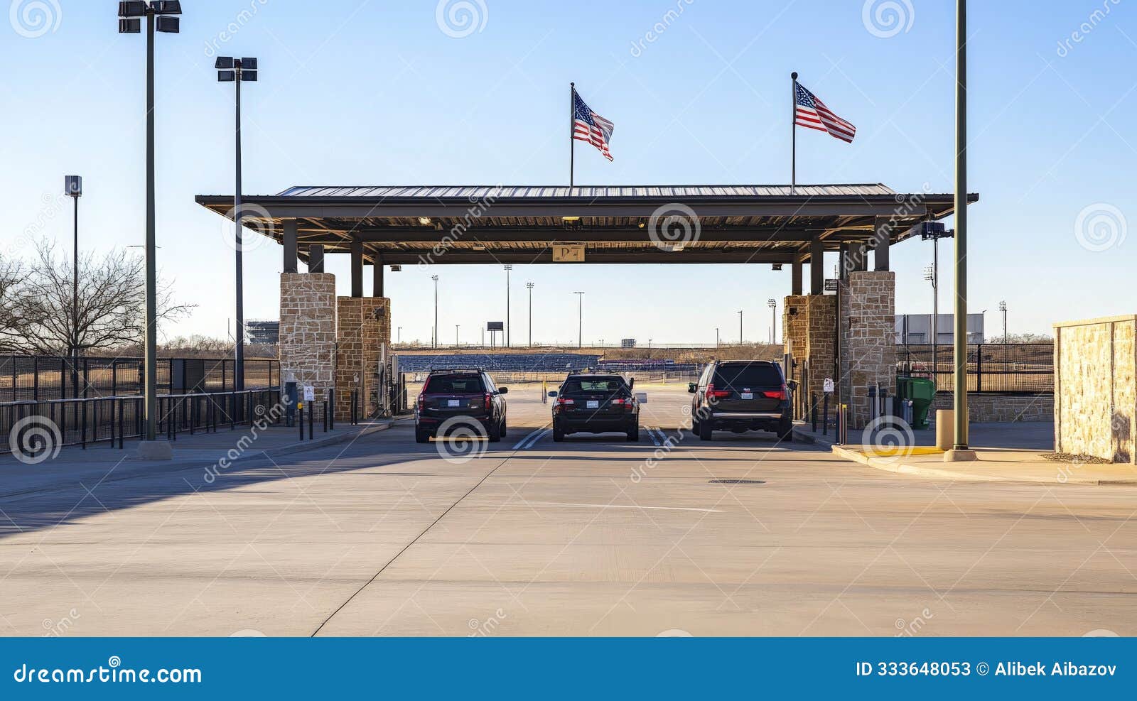 Secure Vehicle Checkpoint with American Flags at Entry Gate on a Sunny ...