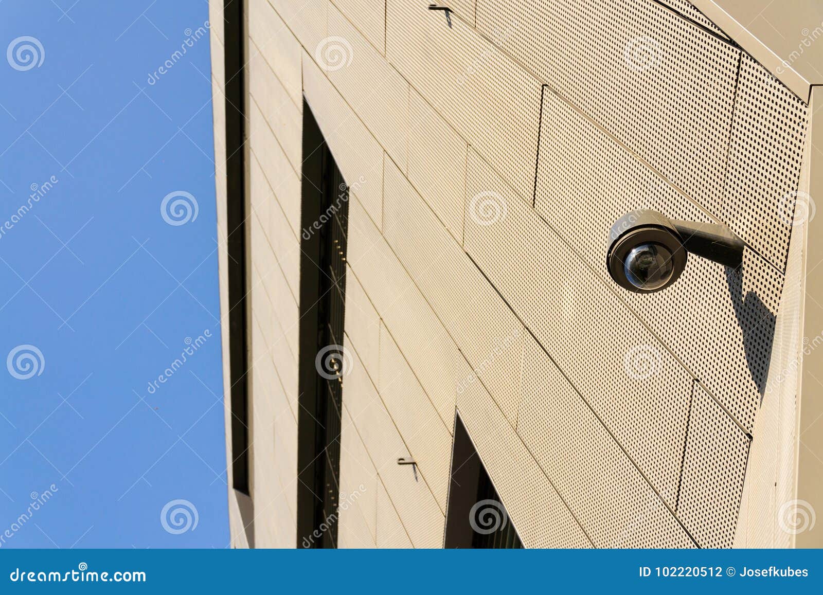 Security Camera Attached To Wall with Windows Background Stock Photo ...