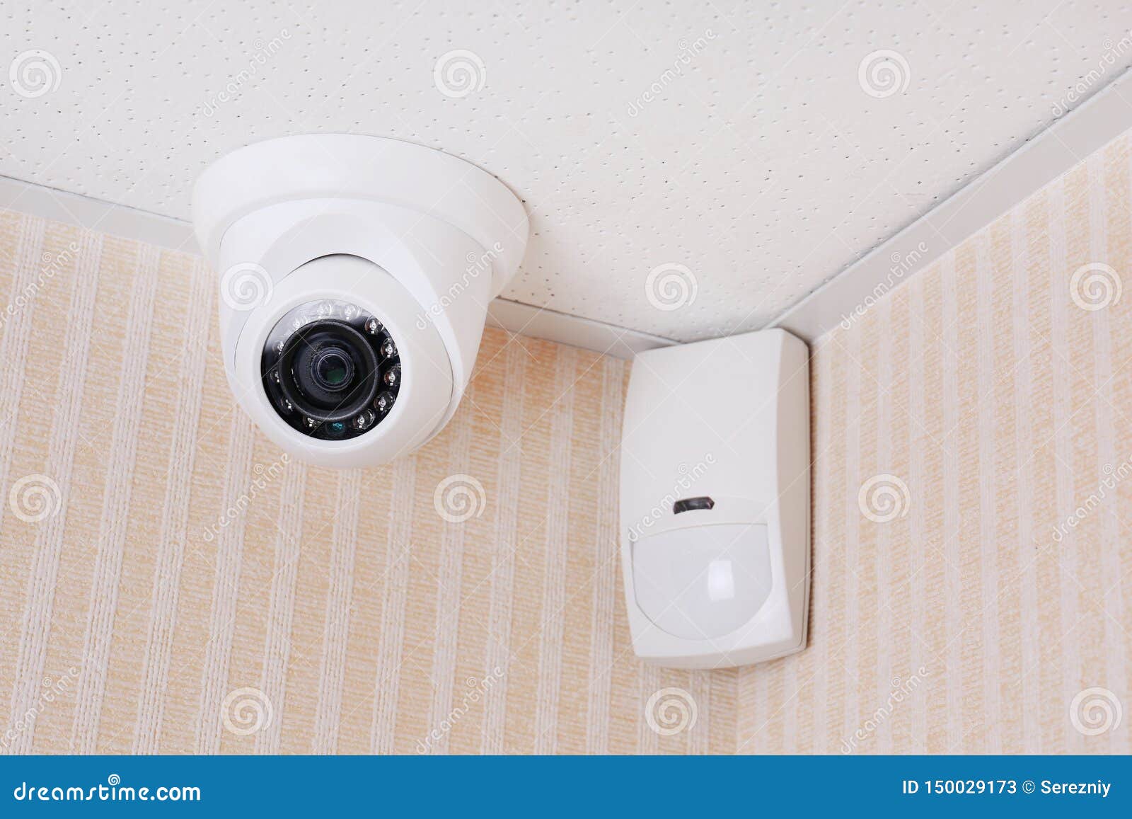 Security Camera and Motion Detector Installed on Ceiling in Room Stock ...