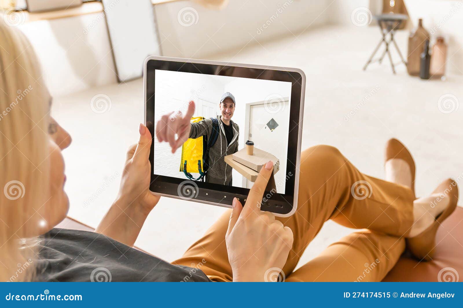 Security Camera System on Tablet App - Delivery Man Holding Package in ...