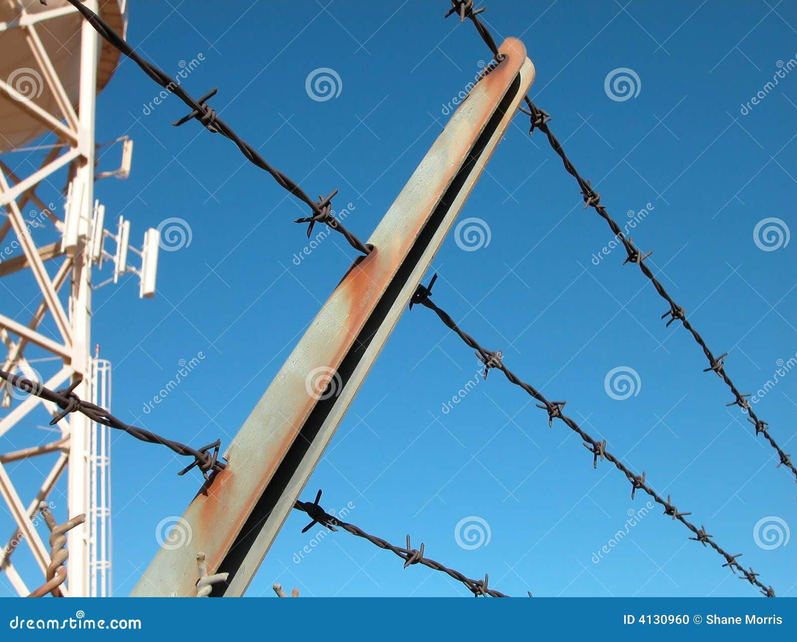 Security Fence with Water Tower Stock Photo - Image of barrier ...