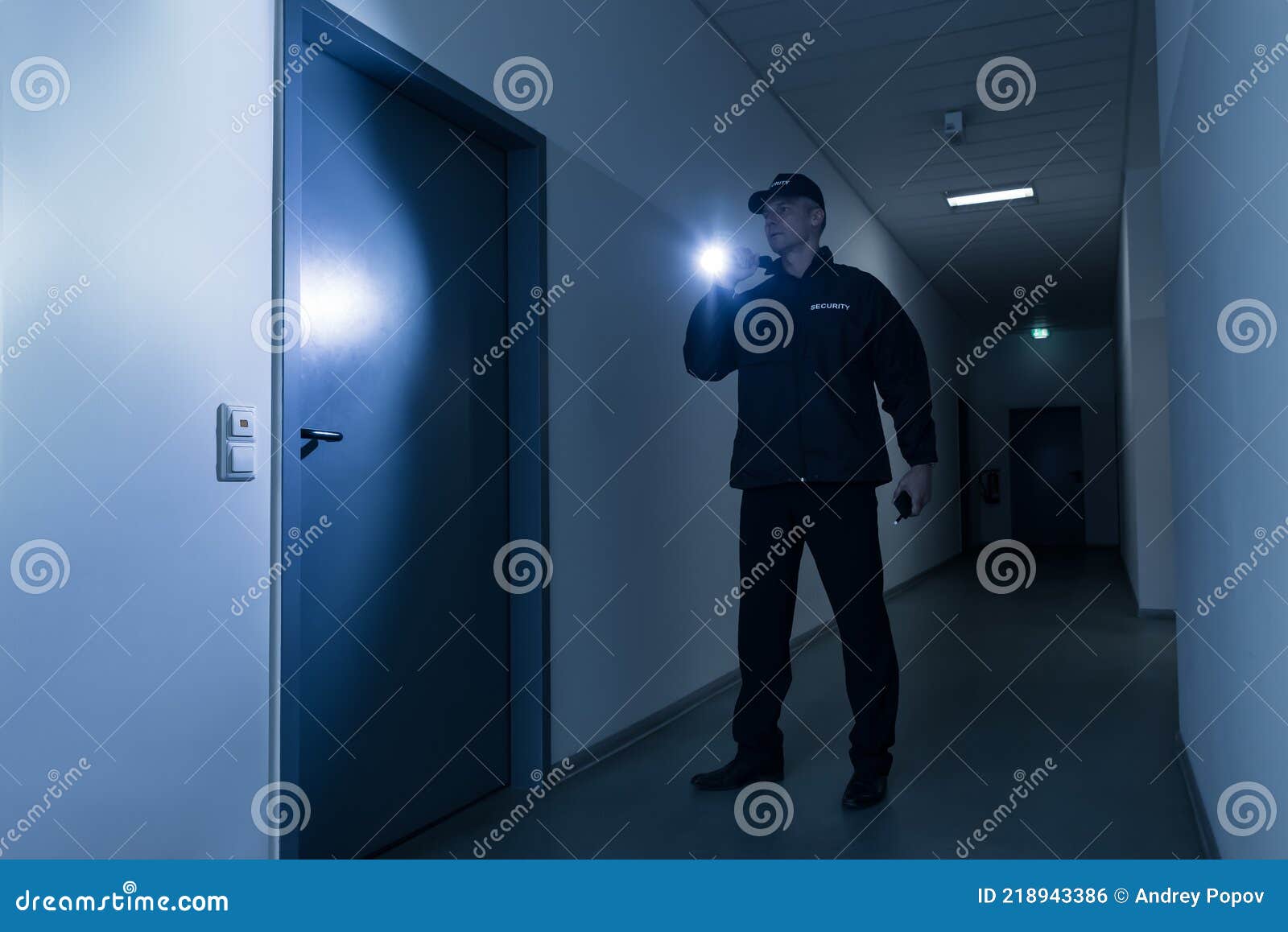 Security Guard with Flashlight Standing in Front of Door Stock Photo ...
