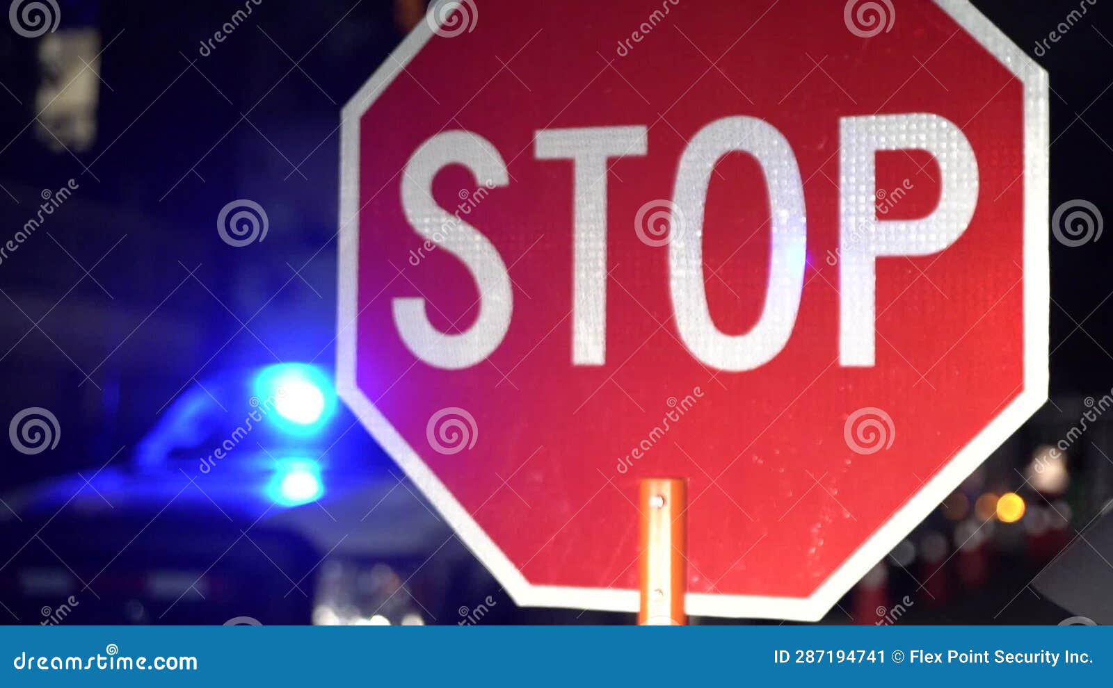 Security Guard Holding Stop Slow Down Sign at Night Construction Site ...