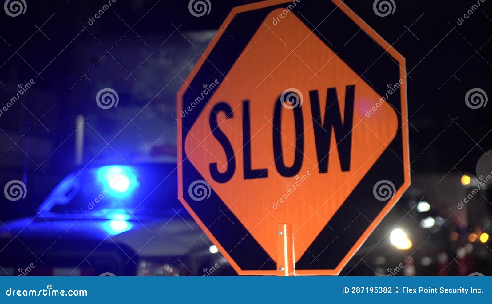 Security Guard Holding Stop Slow Down Sign at Night Construction Site ...