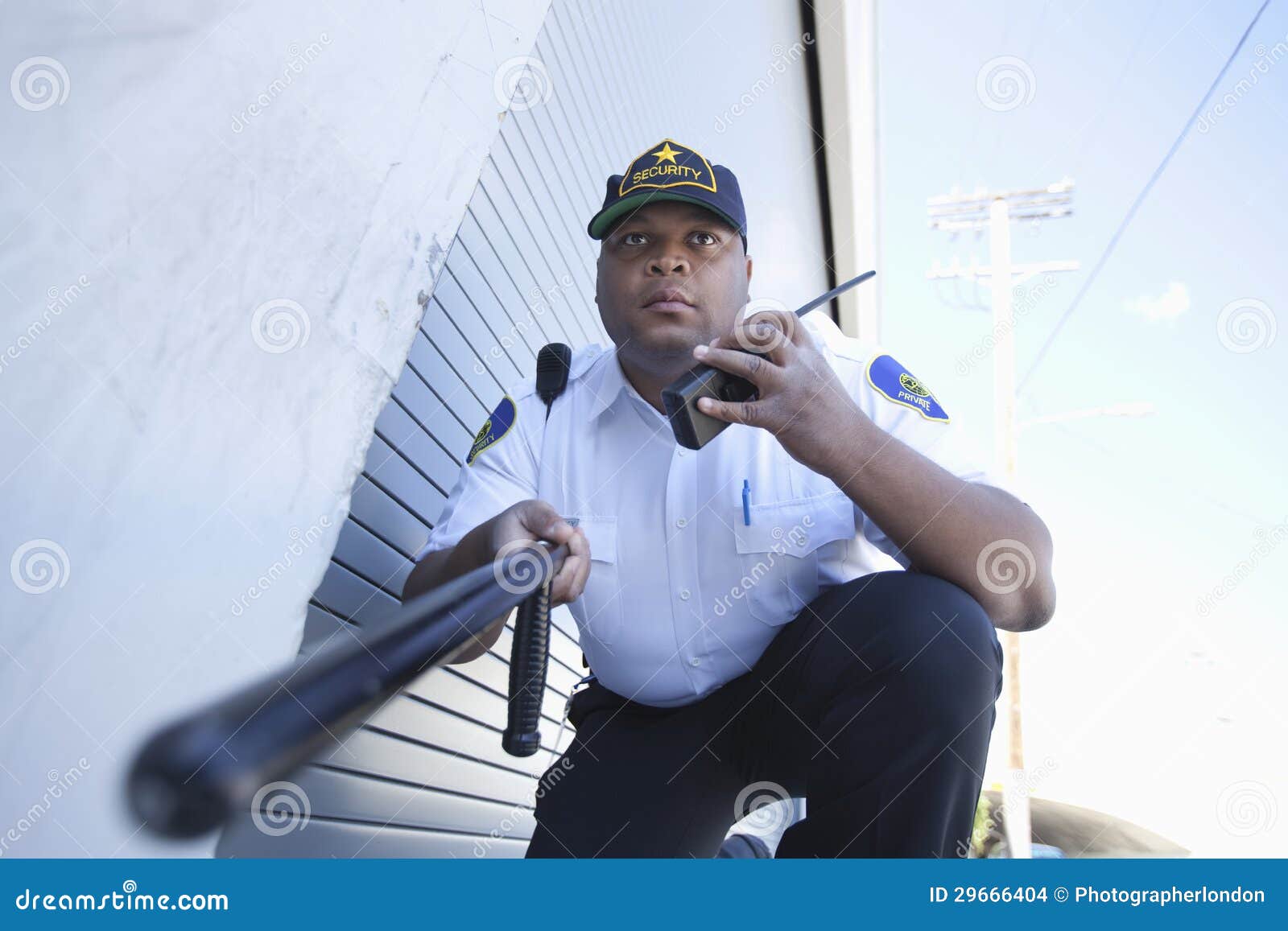 Security Guard Investigates with Walkie Talkie Stock Photo - Image of ...