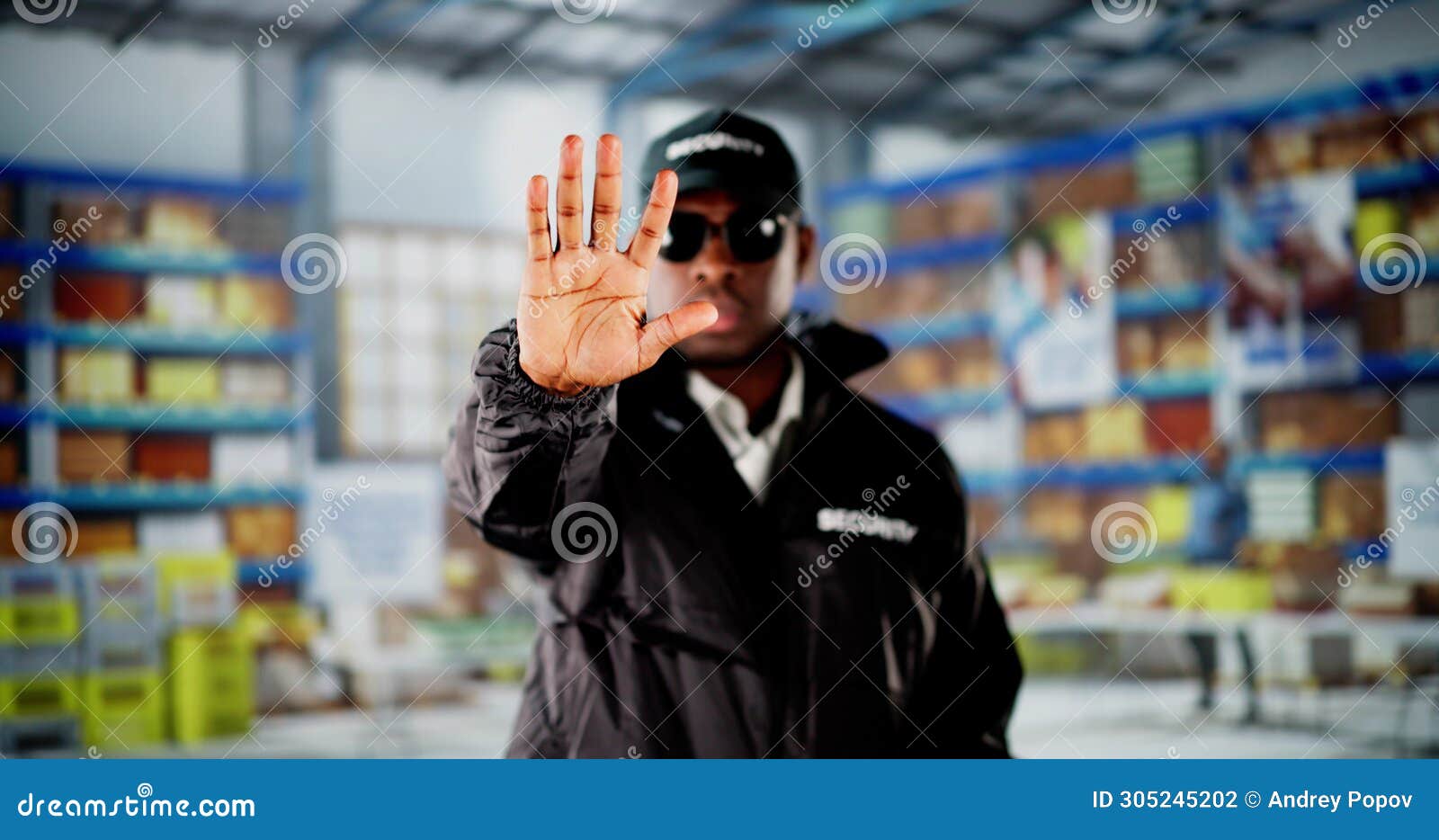 Security Guard in Warehouse Making Stop Gesture Stock Photo - Image of ...