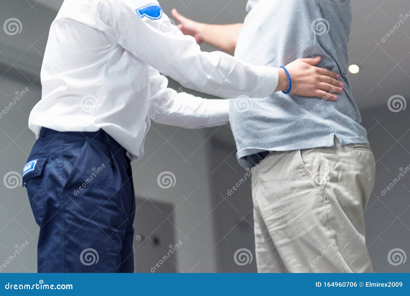 Security Guard Making a Pat-down Procedure for Finding Hidden Objects ...