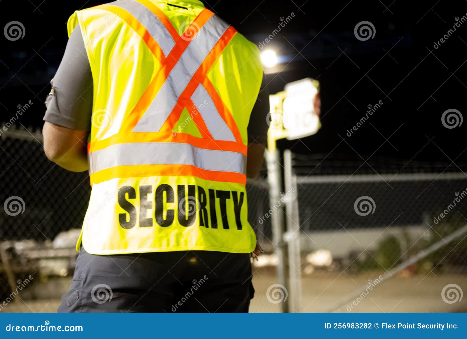 Security Guard Patrolling in Fenced Commercial Area Stock Photo - Image ...