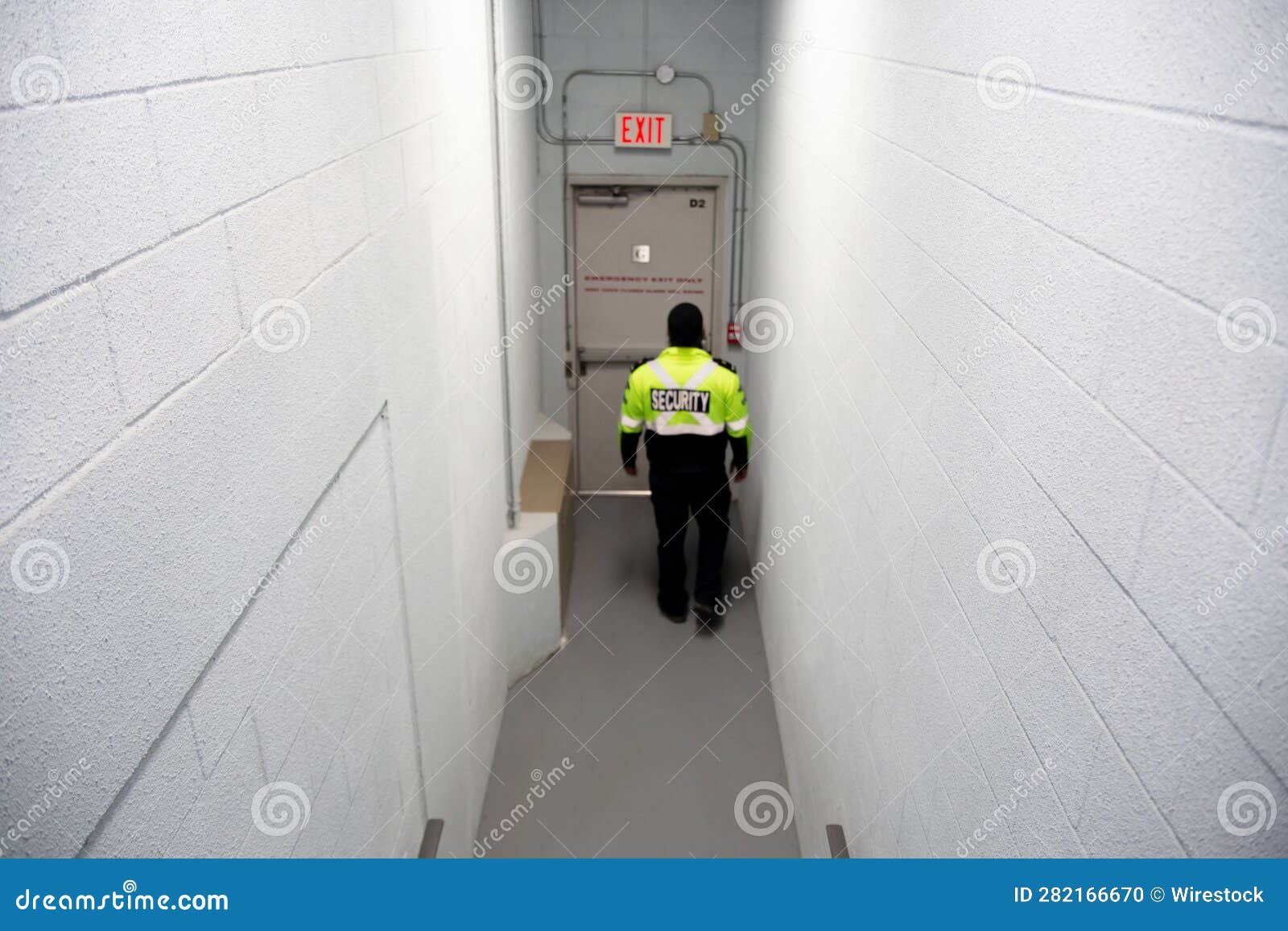 A Security Guard is Patrolling an Office at Night. Stock Photo - Image ...