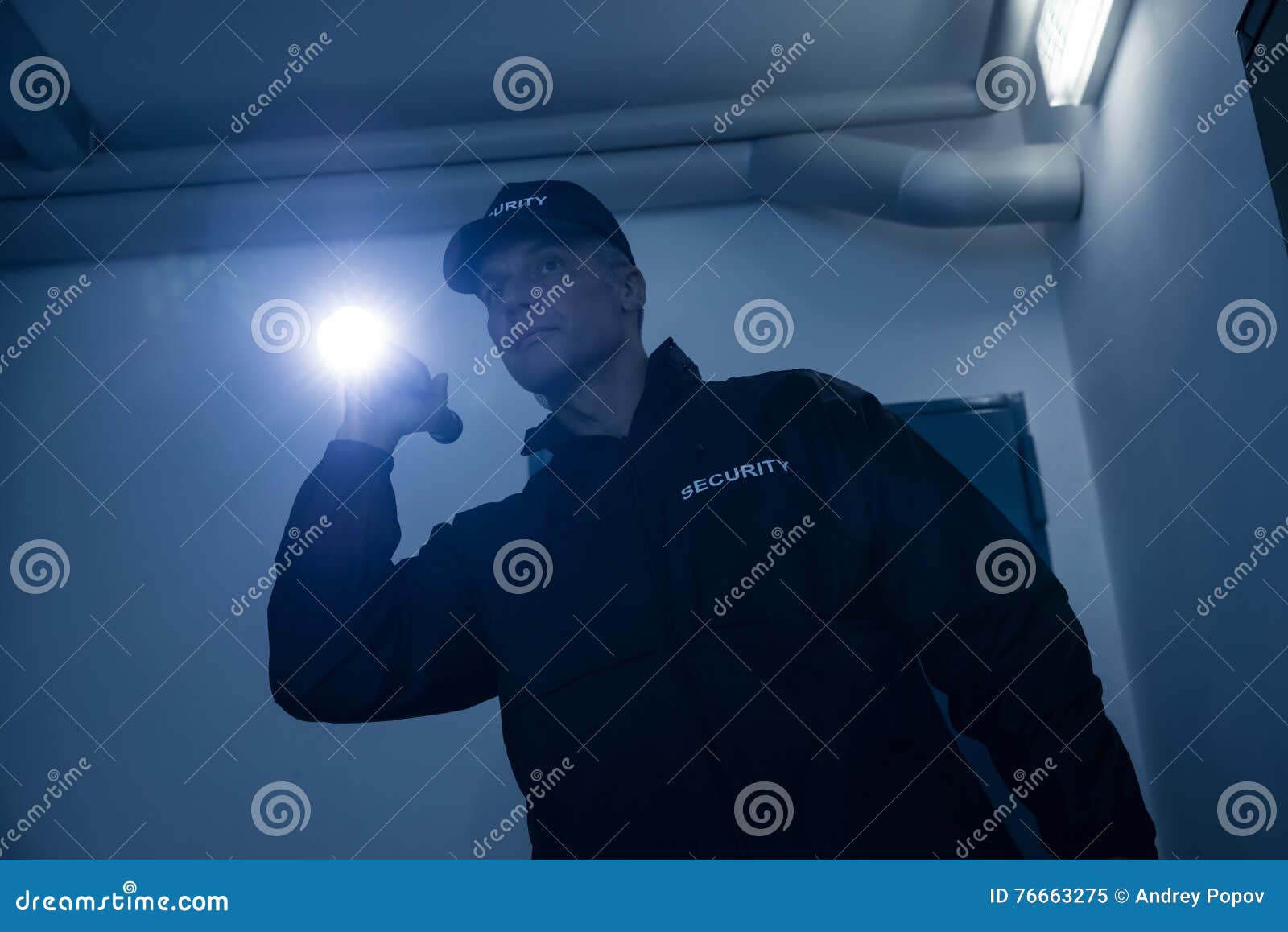 Security Guard Searching with Flashlight in Office Stock Image - Image ...
