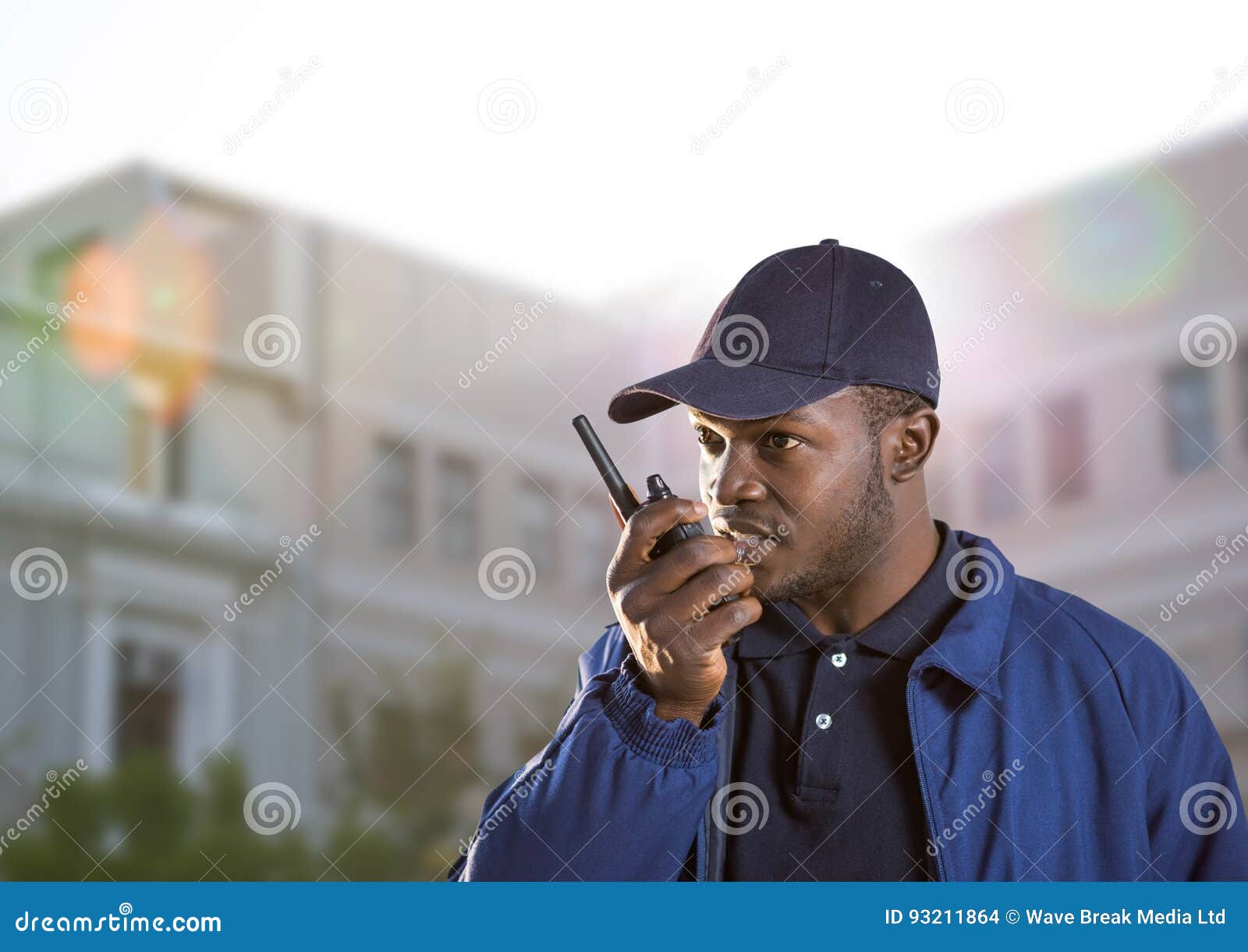 Security Guard Speaking with the Walkie-talkie in Front of a Building ...