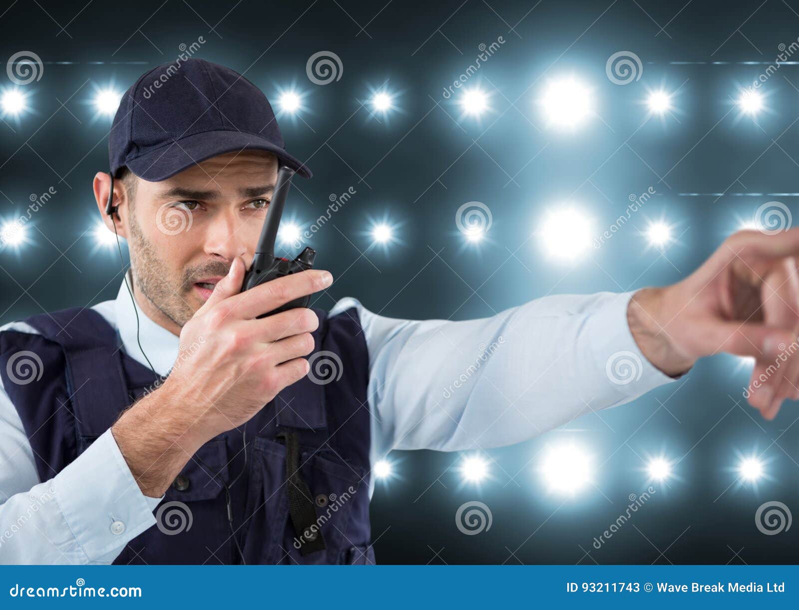 Security Guard Speaking with Walkie-talkie and Pointing Something in a ...