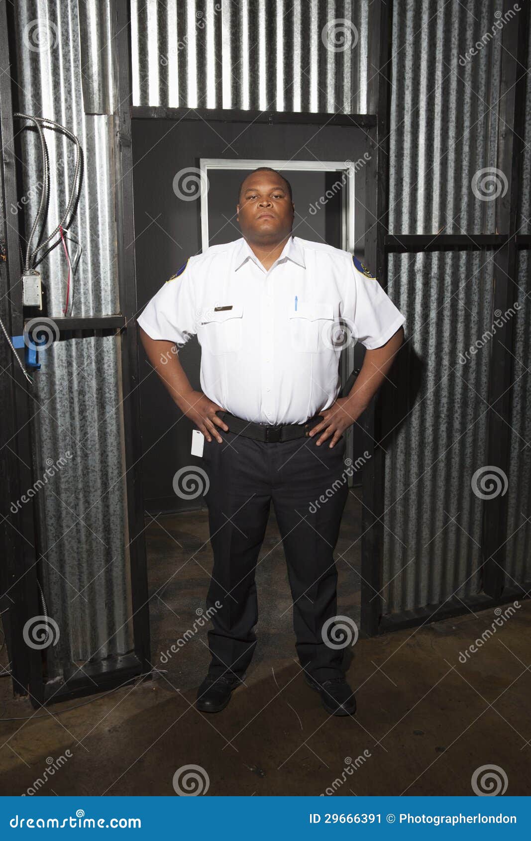 Security Guard Standing at Corrugated Metal Doorway Stock Image - Image ...