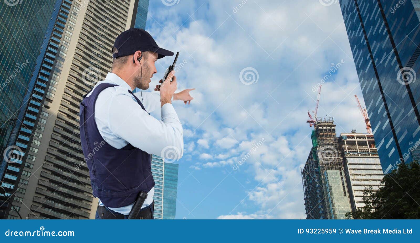 Security Guard Talking on Walkie Talkie and Gesturing while Standing by ...