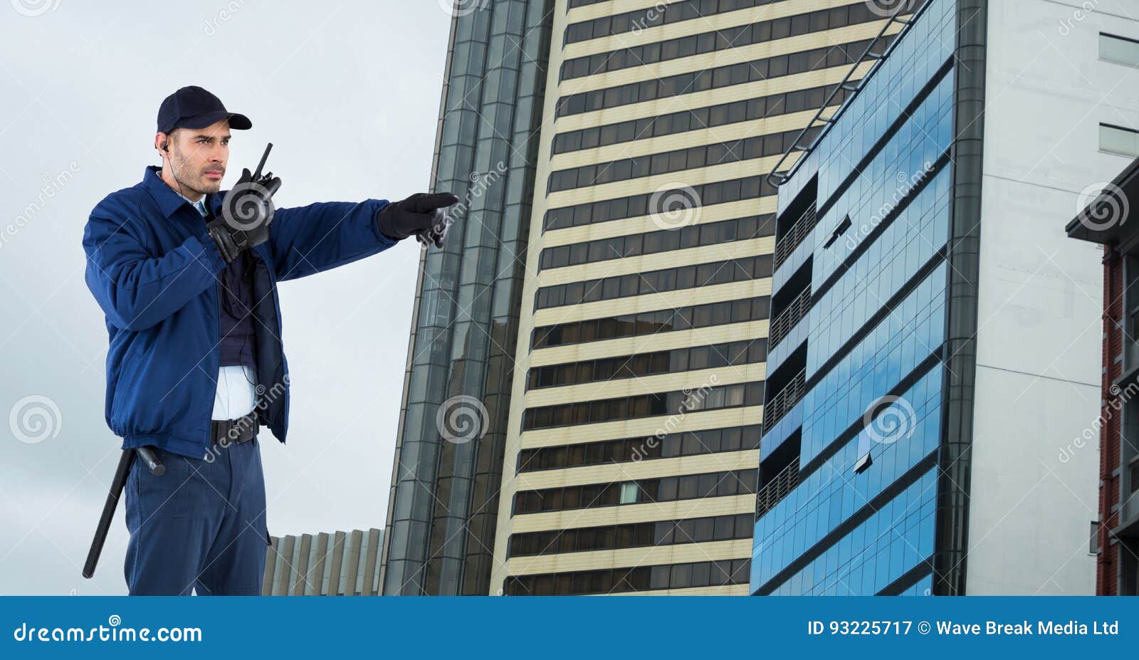 Security Guard Talking on Walkie Talkie while Pointing Towards ...