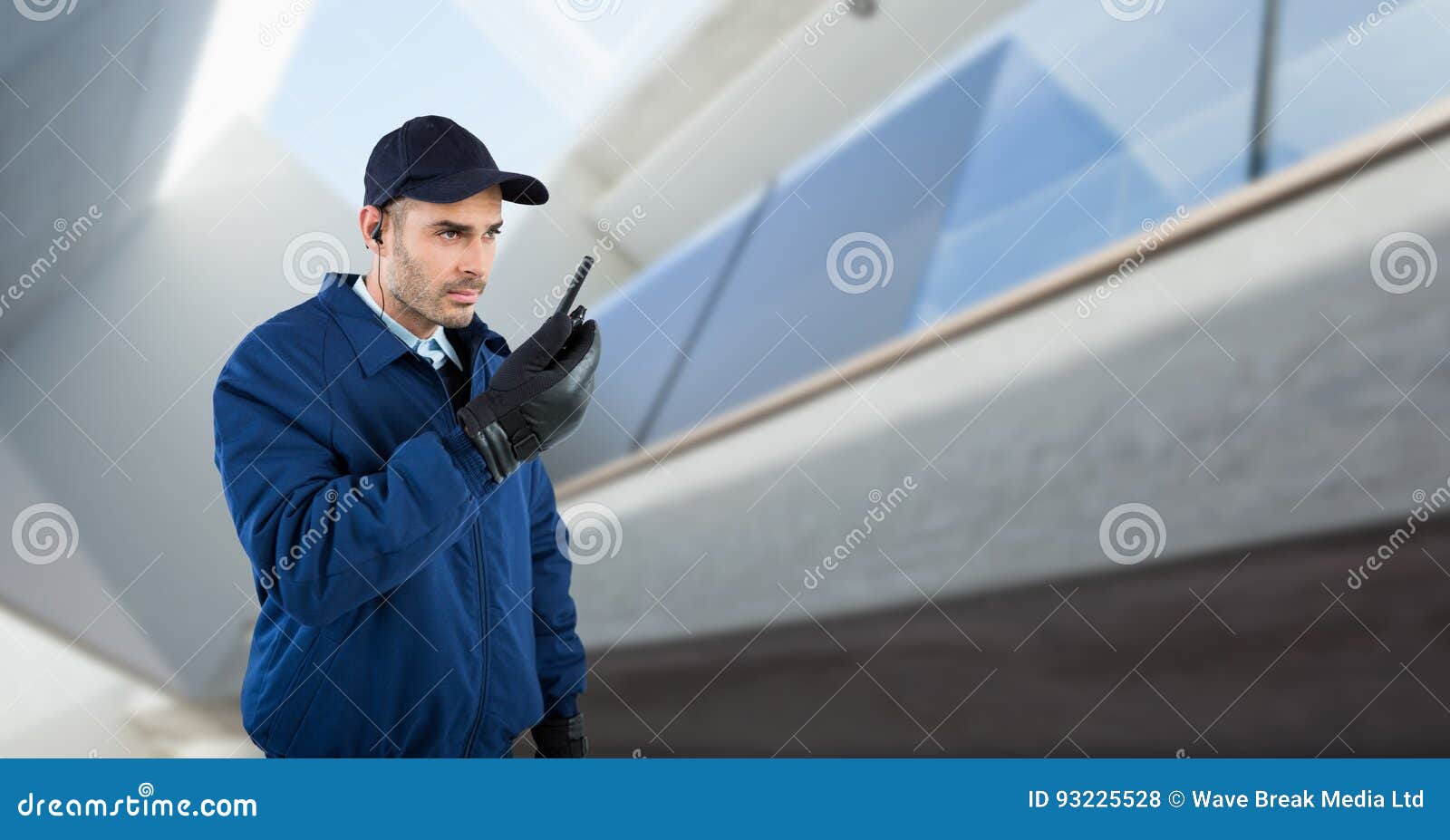 Security Guard Talking on Walkie Talkie while Standing Against ...