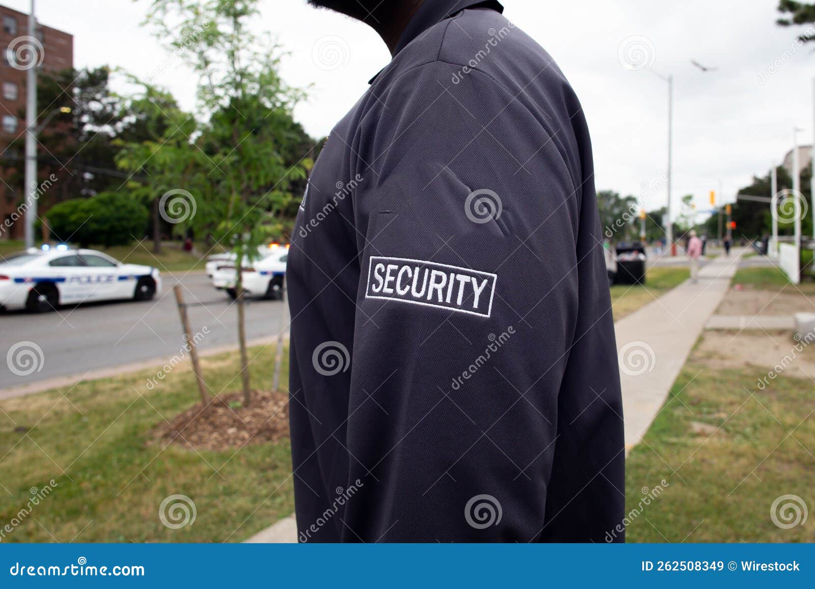 Security Guard in Uniform Patrolling a Residential Area. Stock Image ...