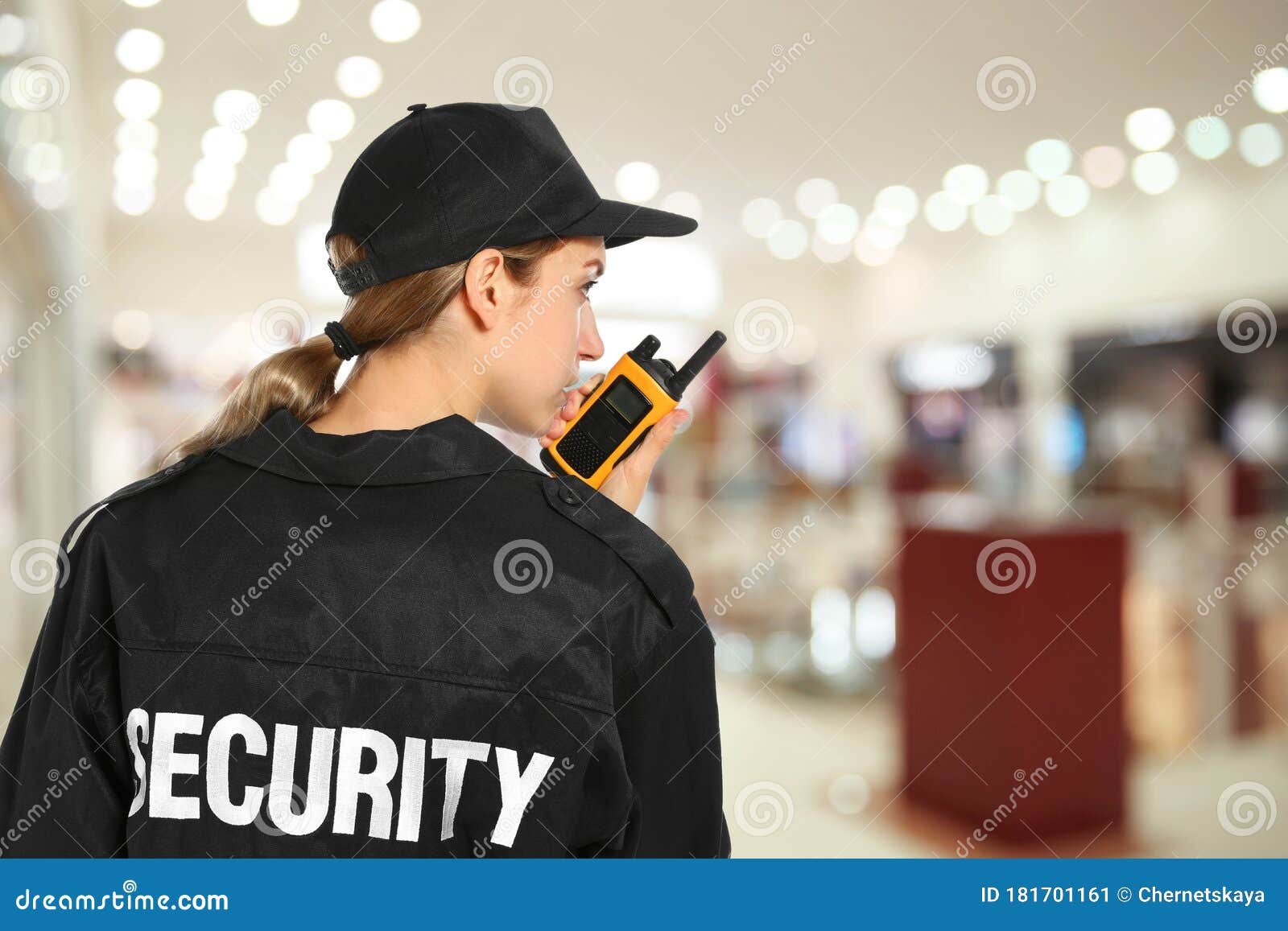 Security Guard Using Portable Radio Transmitter in Shopping Mall Stock ...