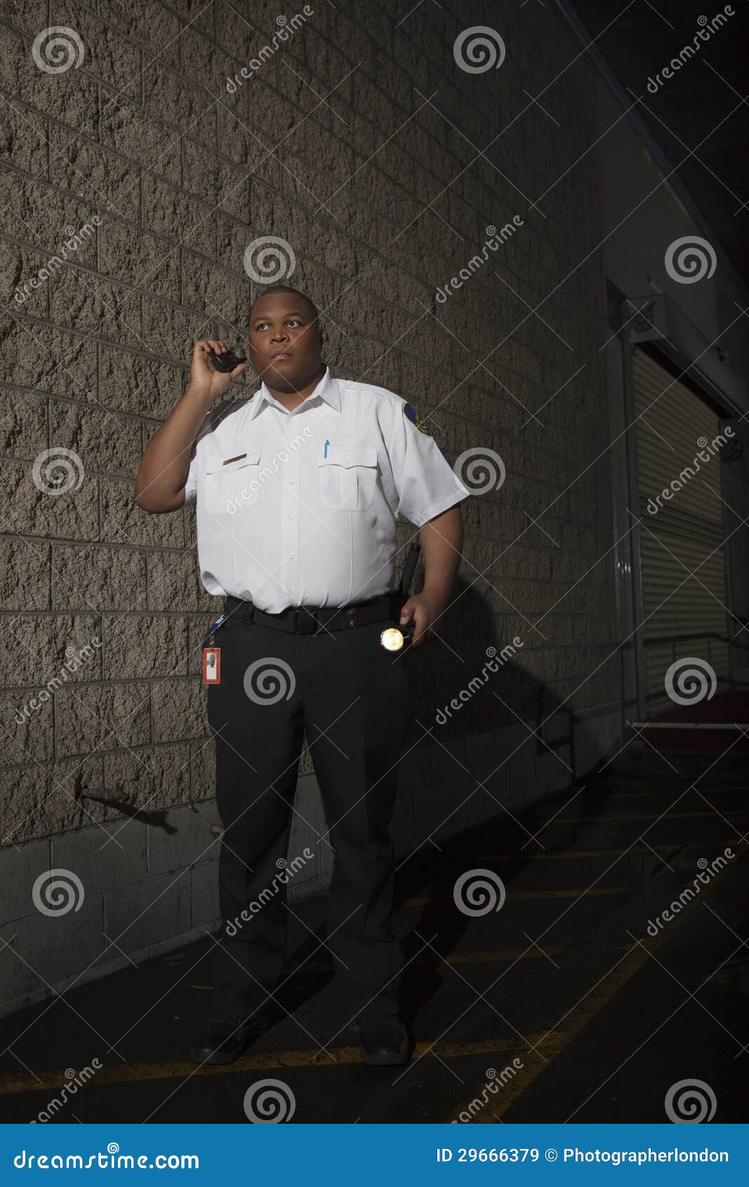 Security Guard Using Walkie Talkie while Patrolling at Night Stock ...