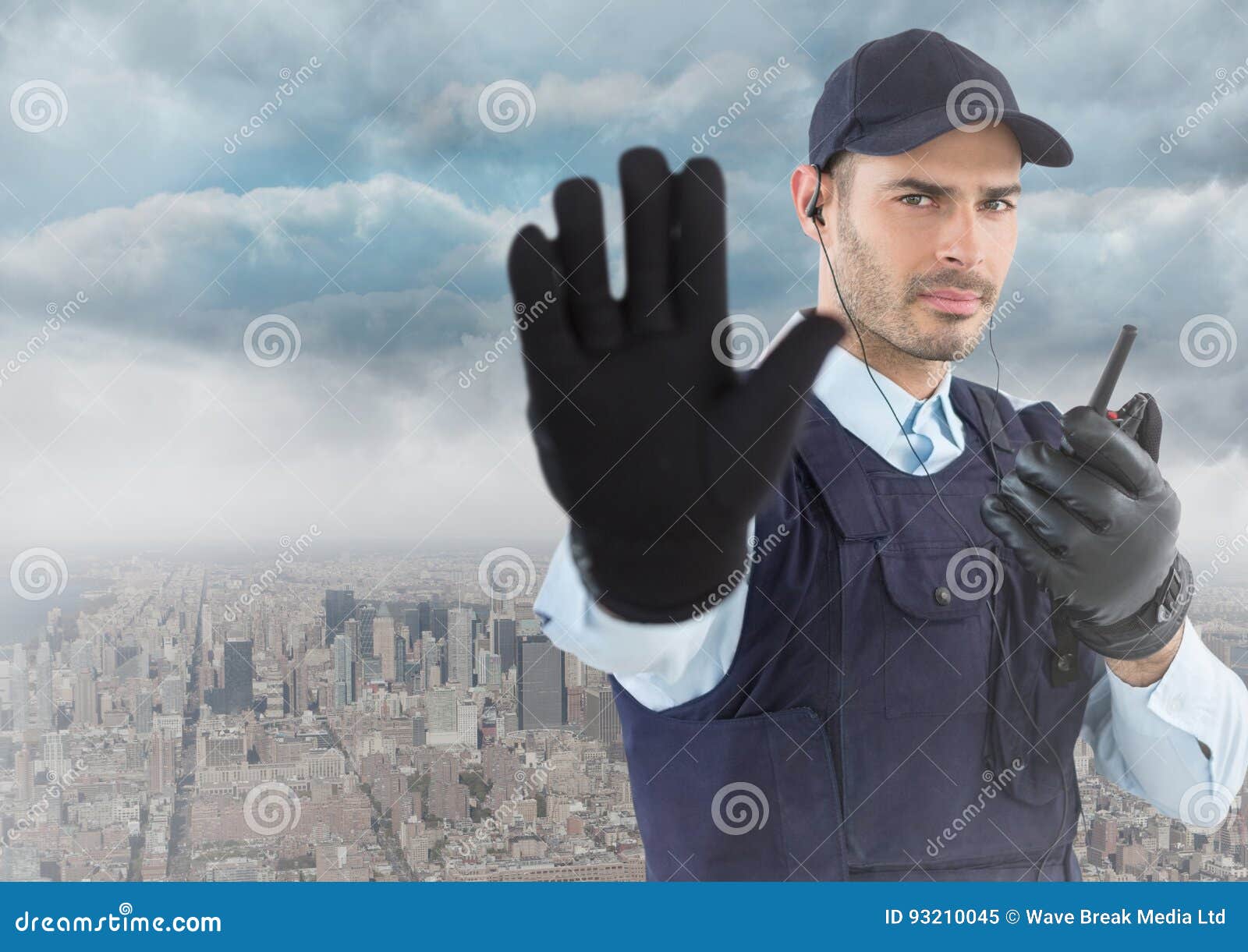 Security Guard with Walkie Talkie and Hand Up Against Skyline and ...