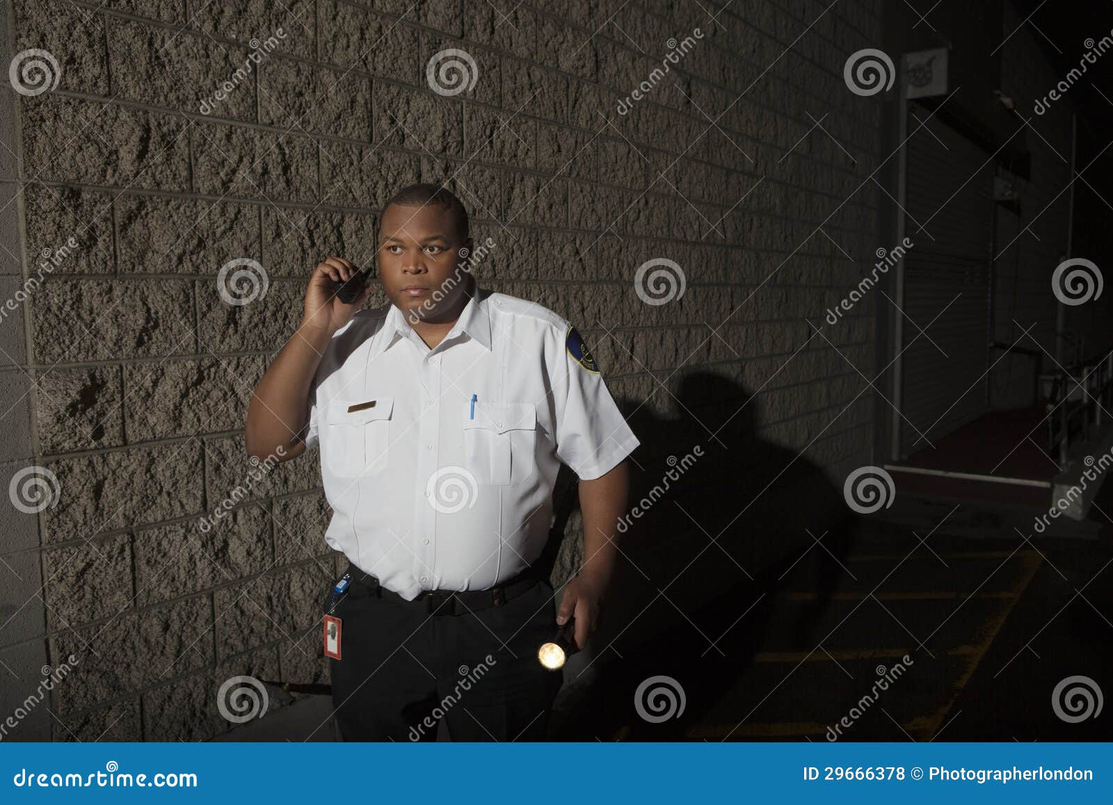 Security Guard With Walkie Talkie And Torch Patrols At Night Stock ...