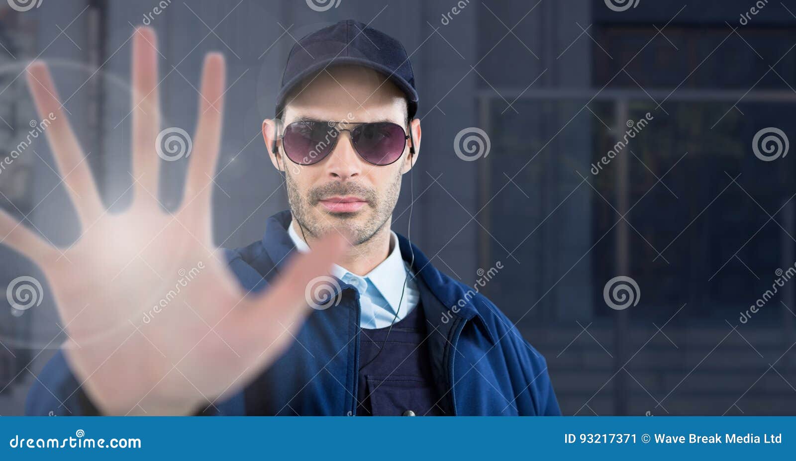 Security Man Outside Blue Background Building with Stop Hand Gesture ...