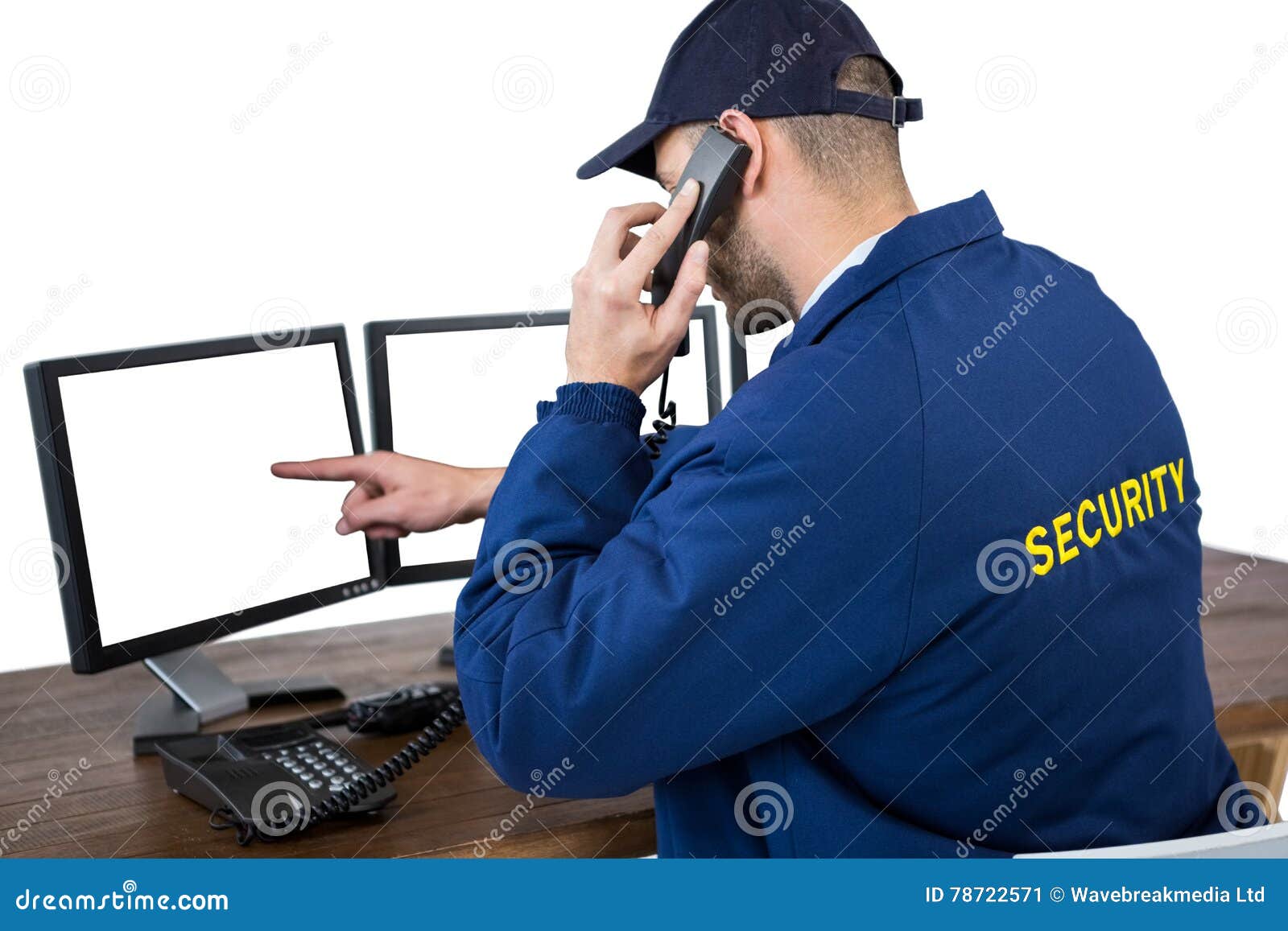 Security Officer Talking on Phone while Pointing at Computer Monitors ...